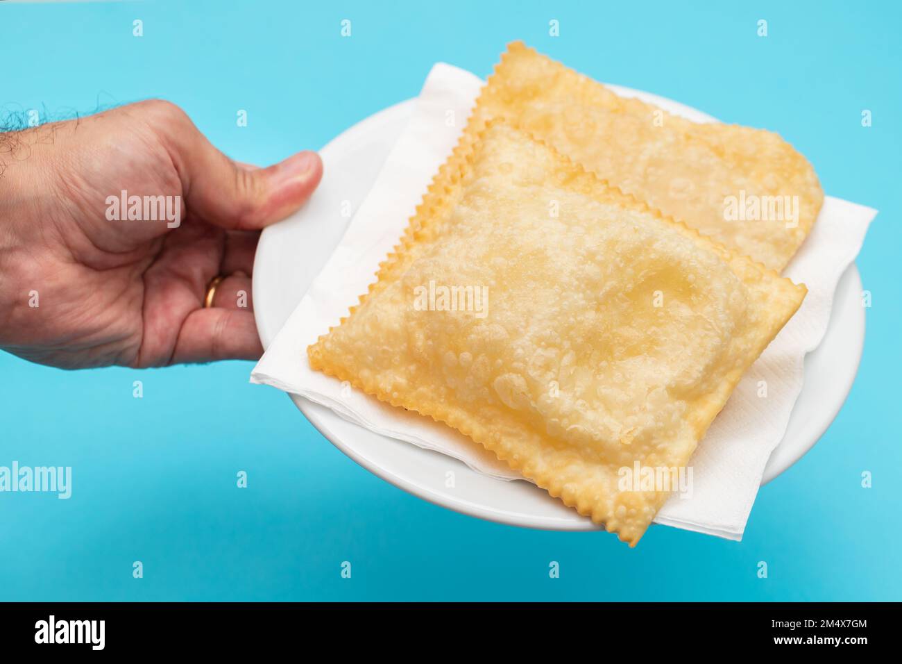 typical brazilian fried pastry on white small plate Stock Photo - Alamy