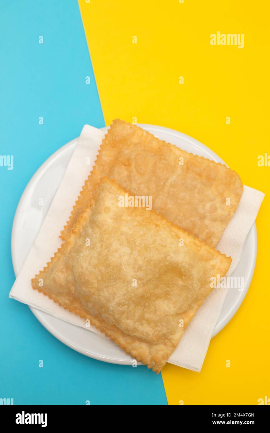 typical brazilian fried pastry on white small plate Stock Photo - Alamy