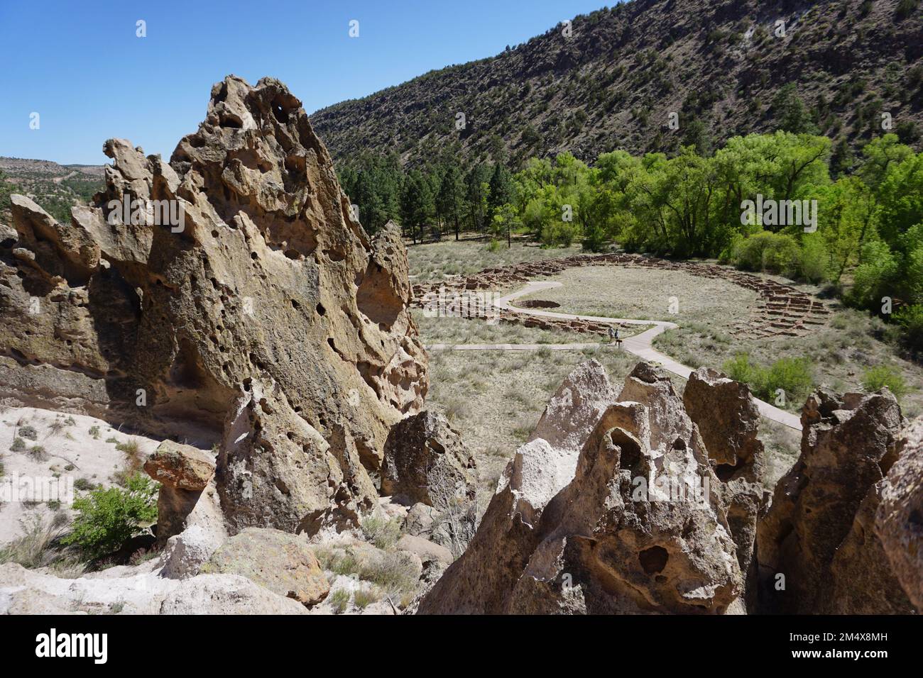 Circular archeological ruins at the base of a mountain and beyond sharp ...