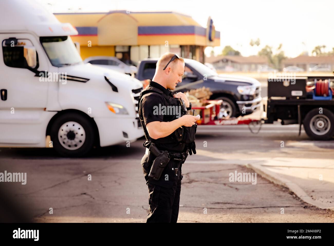 White male caucasian police officer cop standing on street in black ...