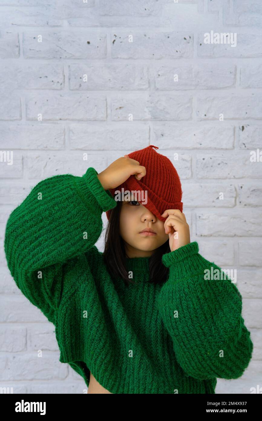 Asian girl covering one eye hi-res stock photography and images - Alamy