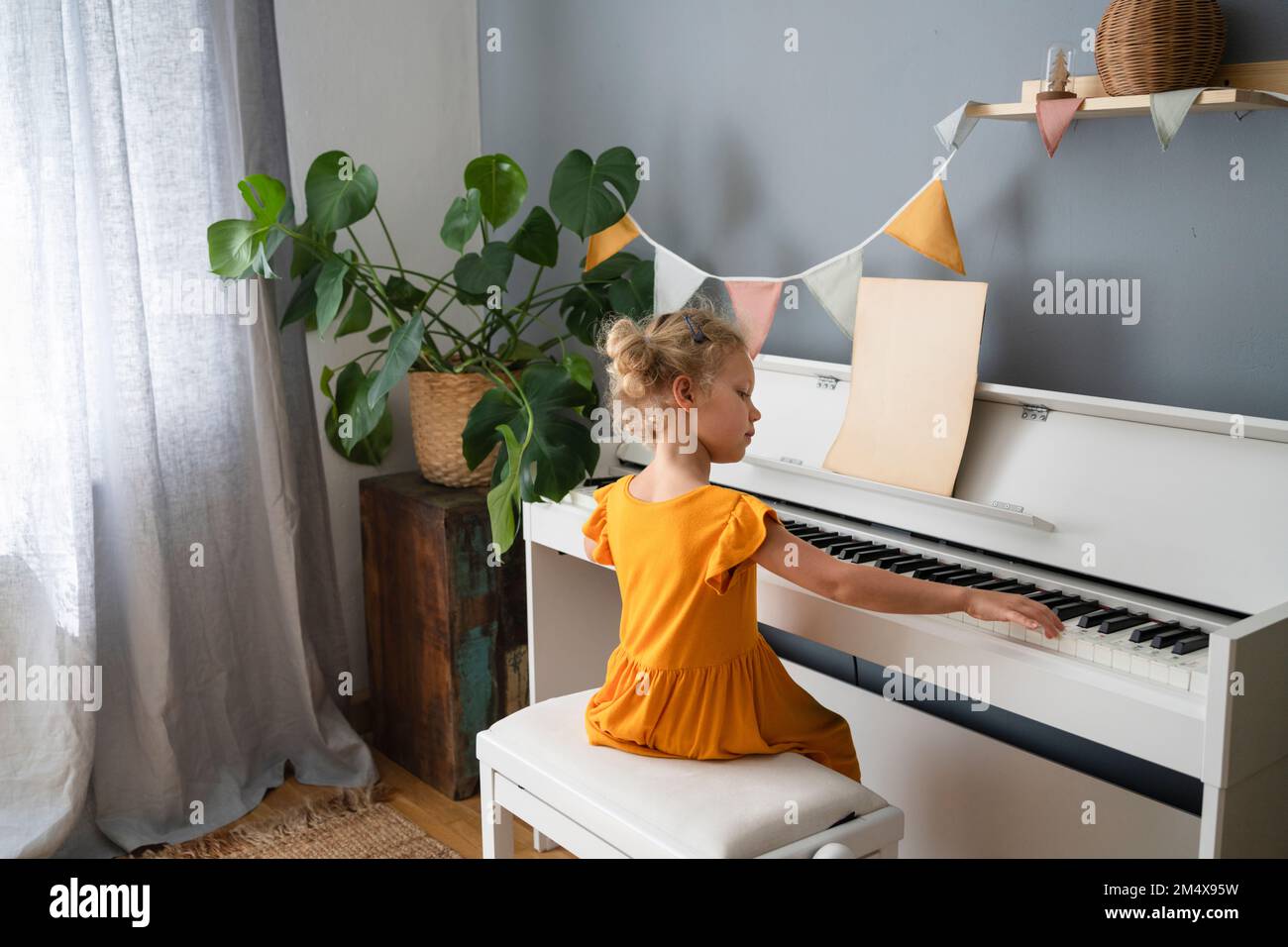 Girl practicing piano at home Stock Photo - Alamy