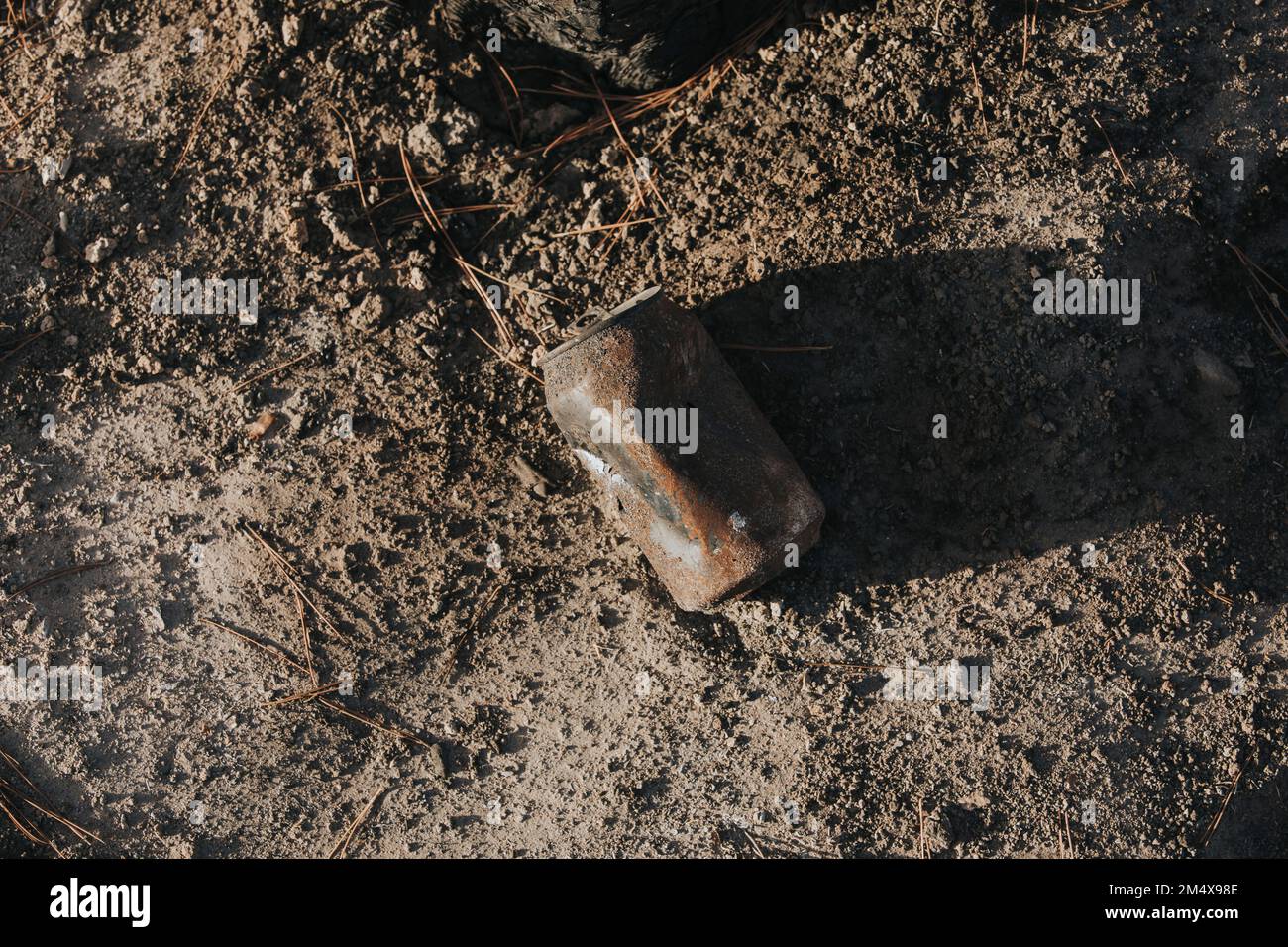 Burnt tin on ground at forest Stock Photo - Alamy