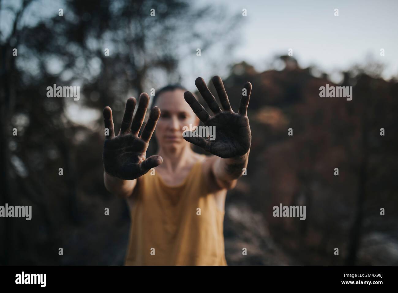 Woman showing hands black with ash standing in burnt forest Stock Photo ...
