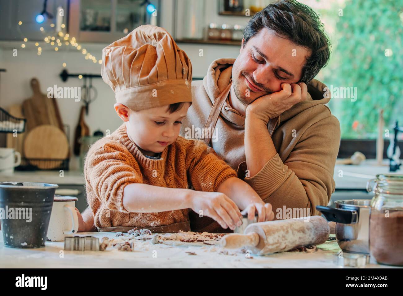 Father with son preparing cookies at home Stock Photo - Alamy