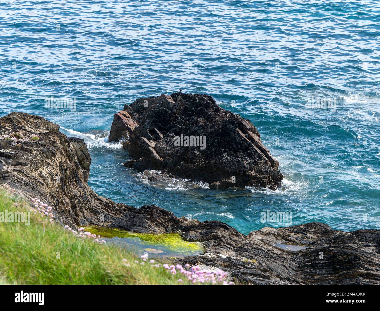 A stone among the blue sea waves in spring. Seaside landscape. Coastal ...