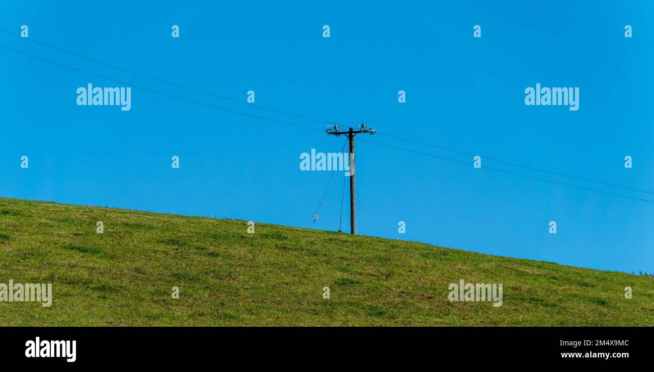 A power lines in a field. Minimalistic landscape, electric post on ...