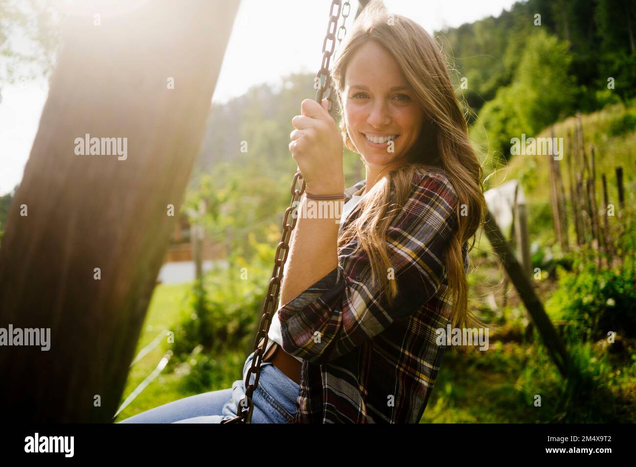 Portrait woman sitting on swing hi-res stock photography and images - Alamy