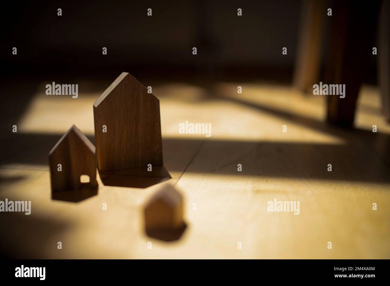 Wooden house models on floor at home Stock Photo - Alamy