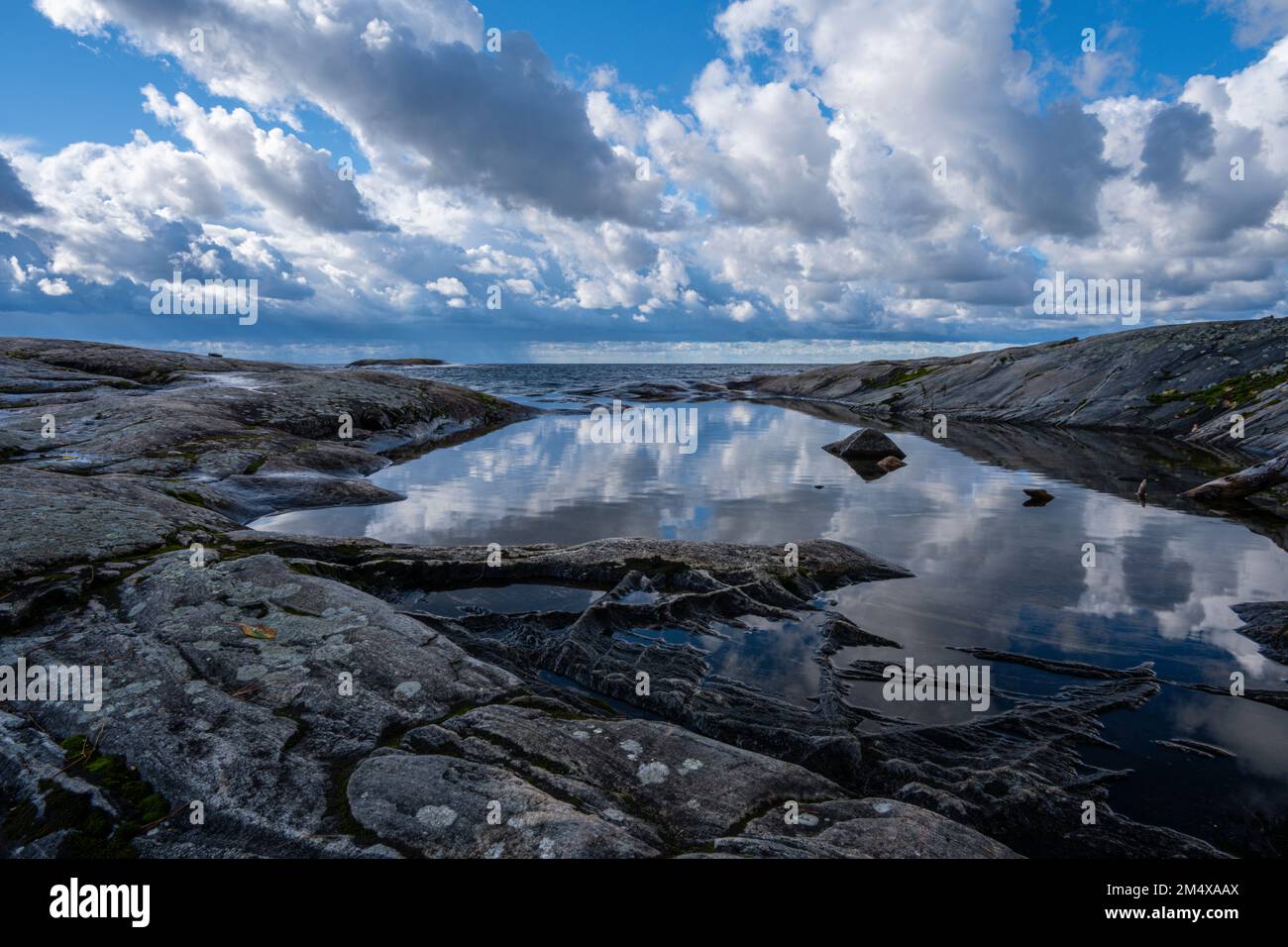 Clouds reflected in a vernal pool, Lake Superior Provincial Park ...