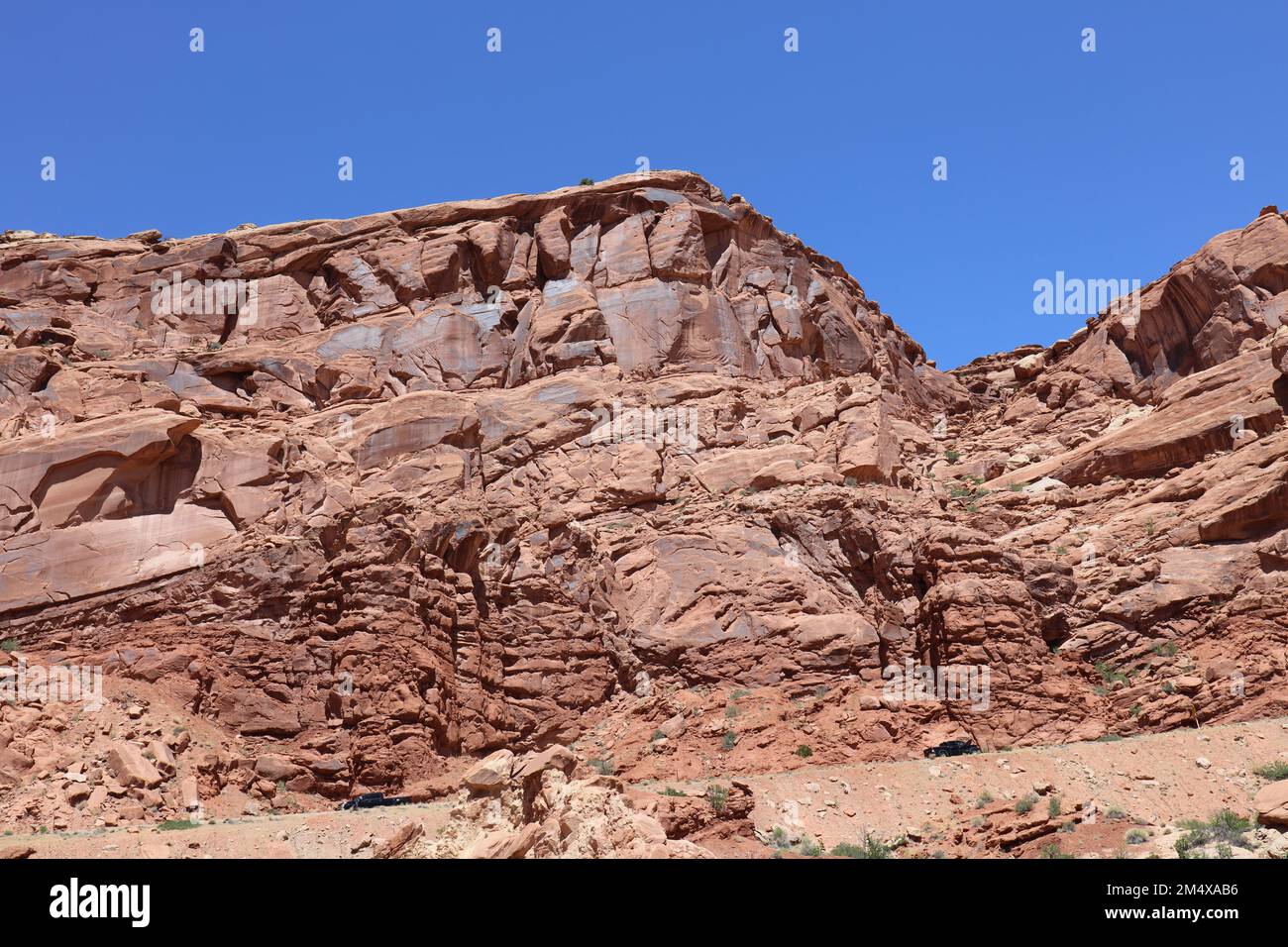 Layers of Entrada Sandstone behind the road leading into Arches ...