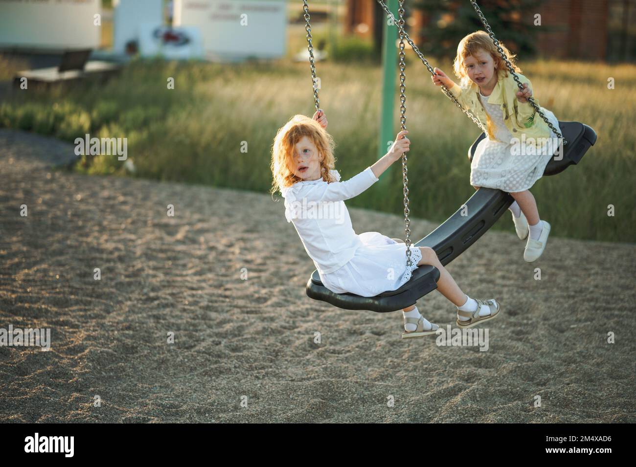 Two girls swing hi-res stock photography and images - Alamy