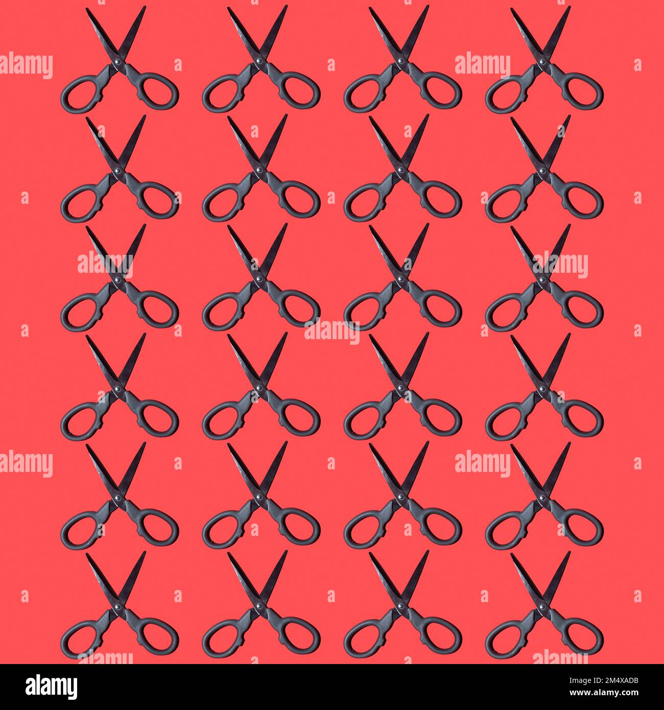 Pattern of scissors flat laid against red background Stock Photo - Alamy