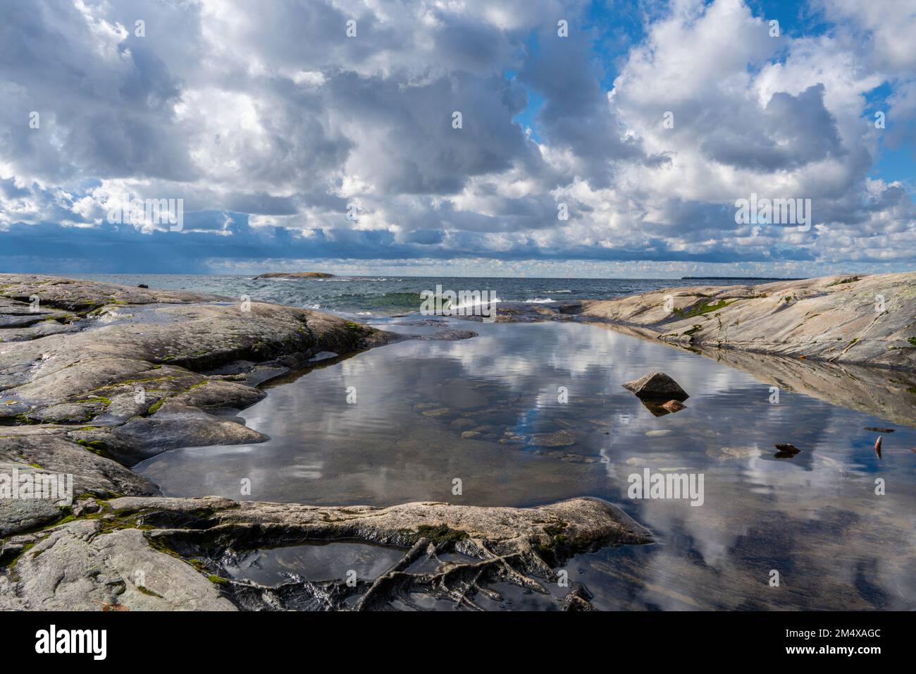 Clouds reflected in a vernal pool, Lake Superior Provincial Park ...
