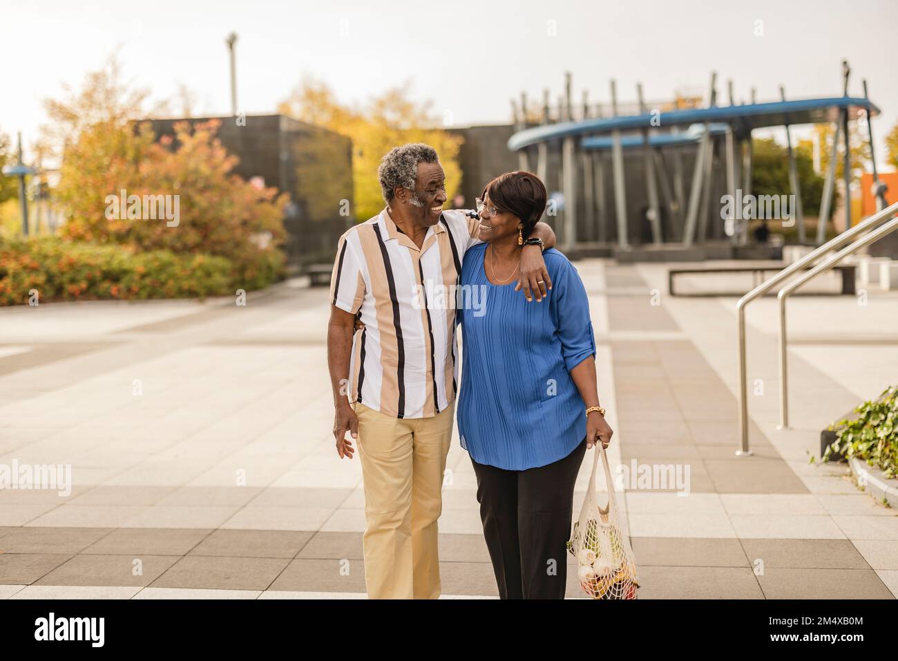 Man walking arm around woman hi-res stock photography and images - Alamy
