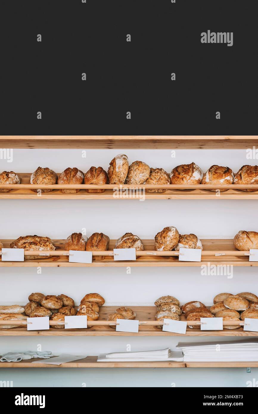 Fresh breads arranged on display at store Stock Photo - Alamy