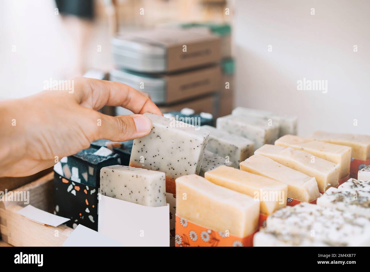 Woman picking scented soap bar at zero waste shop Stock Photo - Alamy