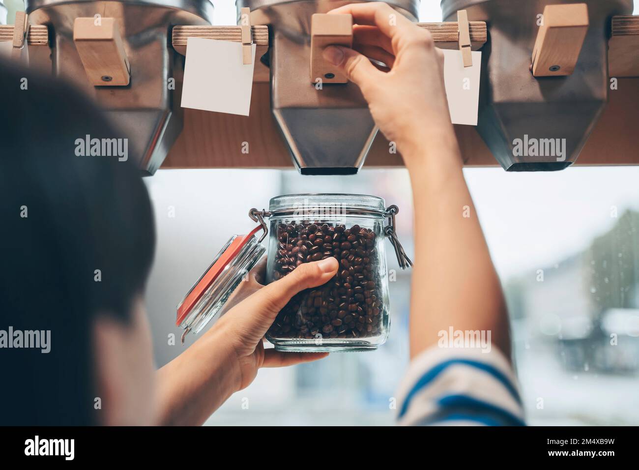 Woman filling mason jar with kidney beans at convenience store Stock ...