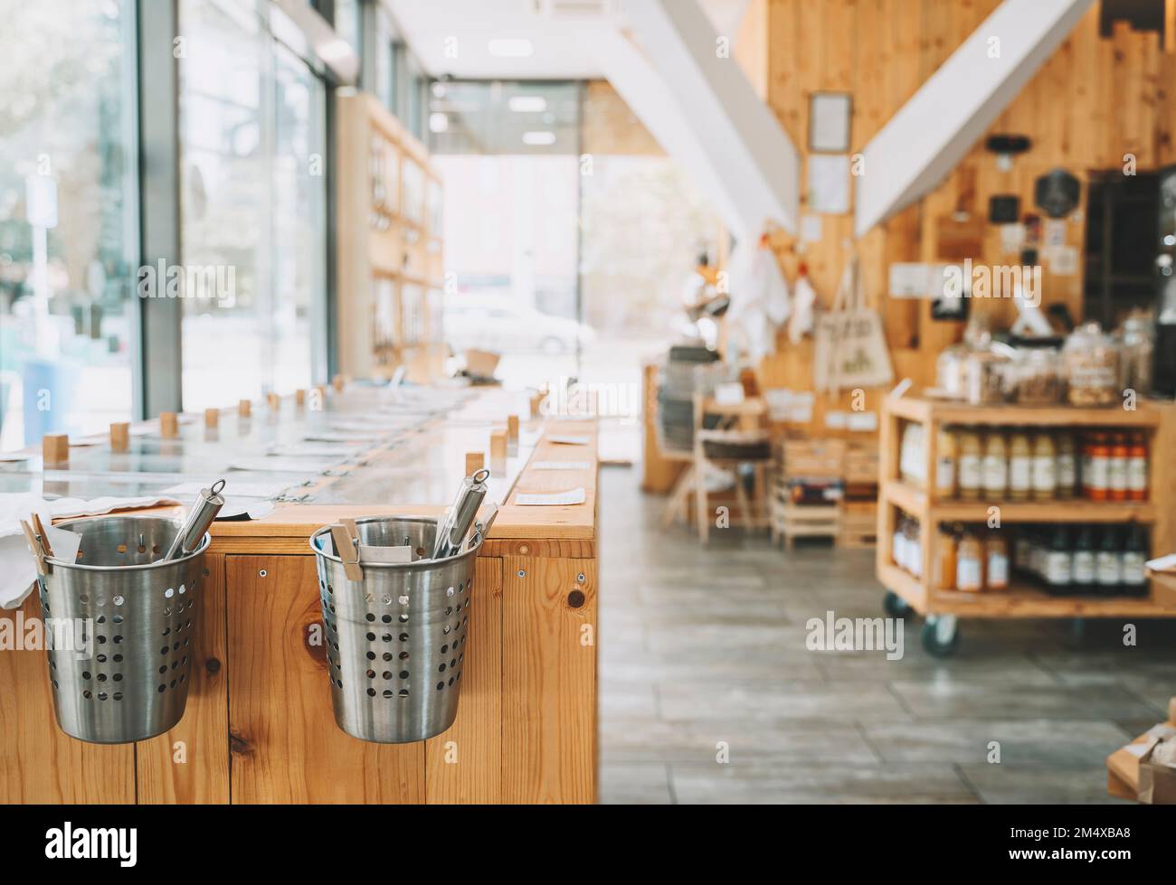 Small containers on wooden counter in shop Stock Photo - Alamy