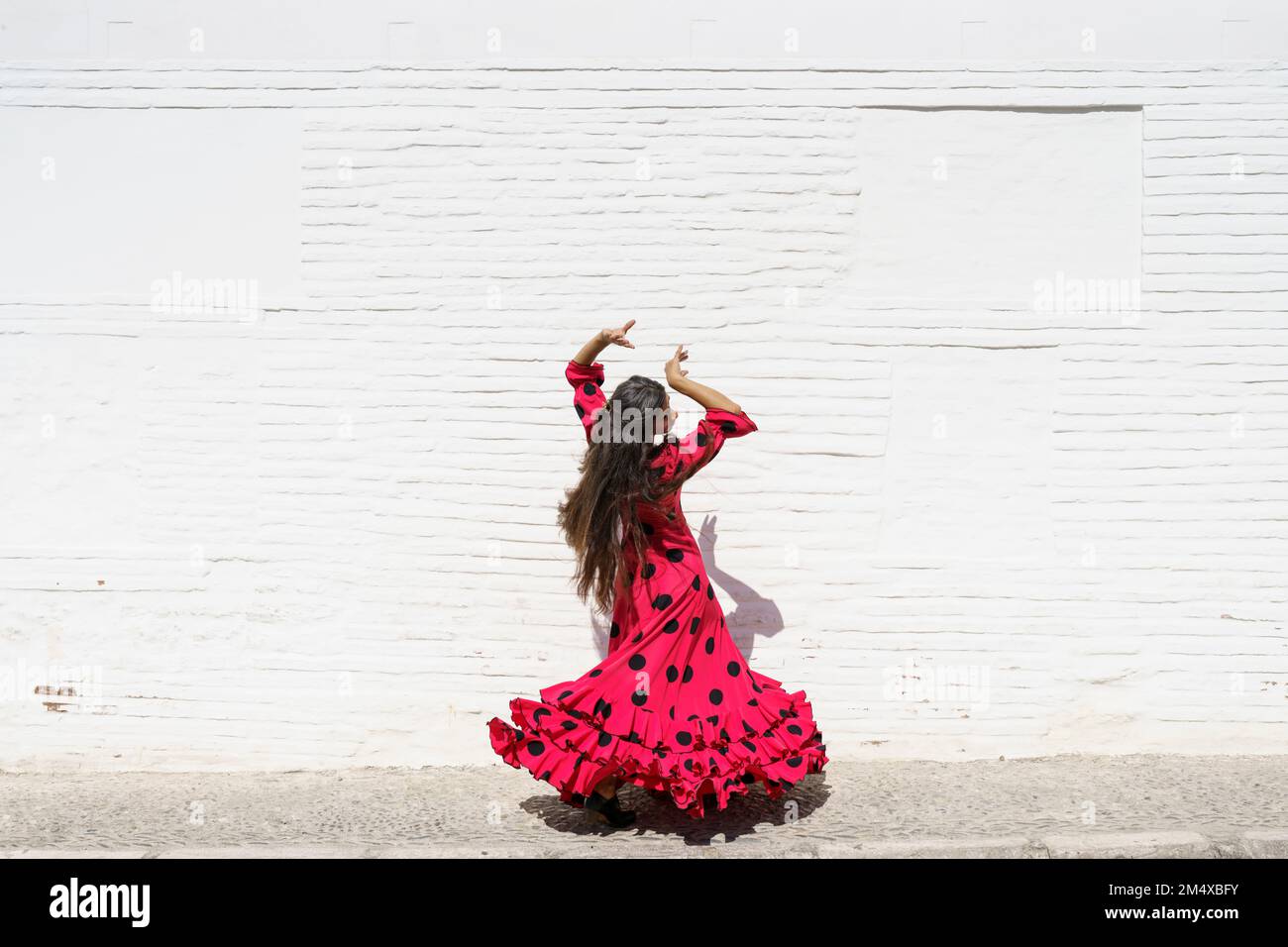 Flamenco dancer spinning in front of white wall Stock Photo - Alamy