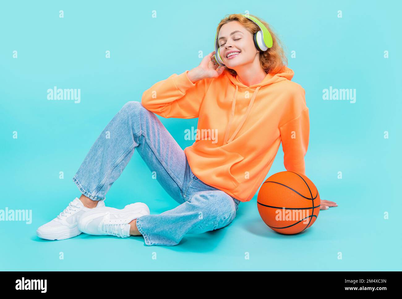 glad redhead basketball woman player on color background. basketball ...