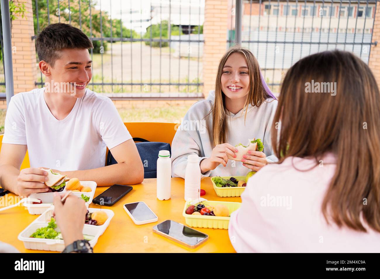 Four friends eating food in hi-res stock photography and images - Alamy