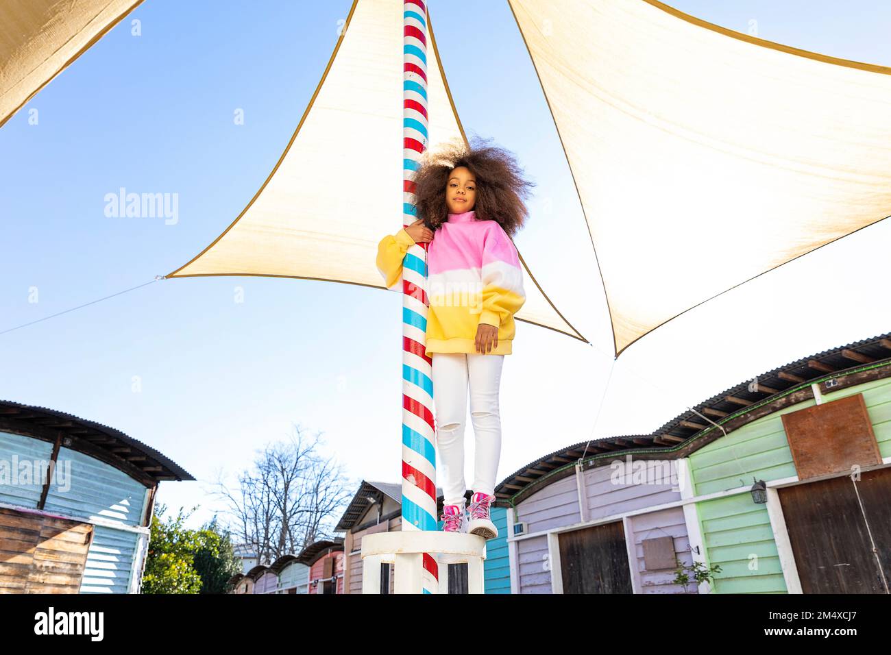 Children playing on pole hi-res stock photography and images - Alamy