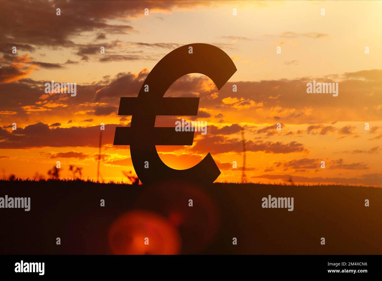 Euro money sign at sunset in the rays of the setting sun. Sunset ...