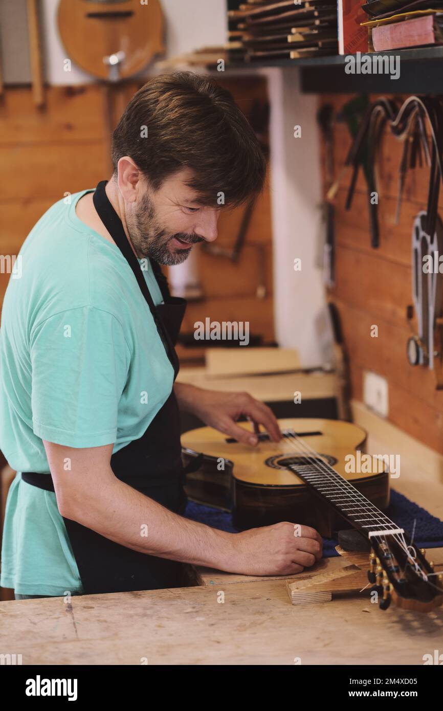 Luthier making flamenco guitar in workshop Stock Photo - Alamy