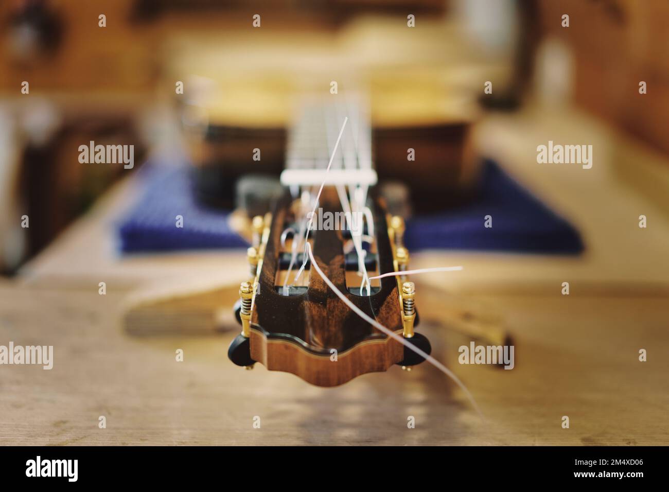 Fretboard of guitar on workbench in workshop Stock Photo - Alamy
