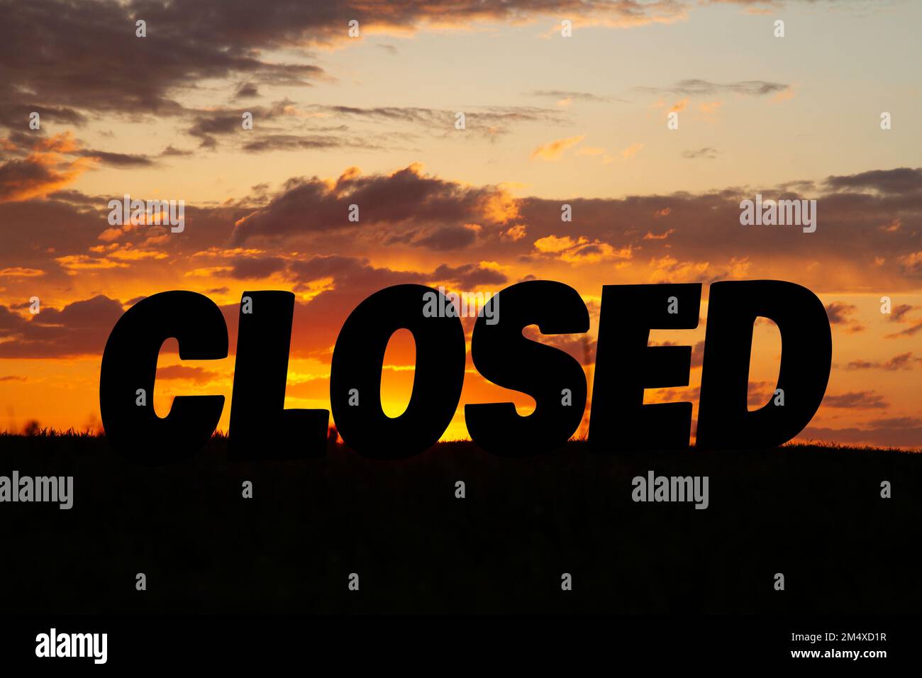 The inscription is closed against the background of a bright sunset ...