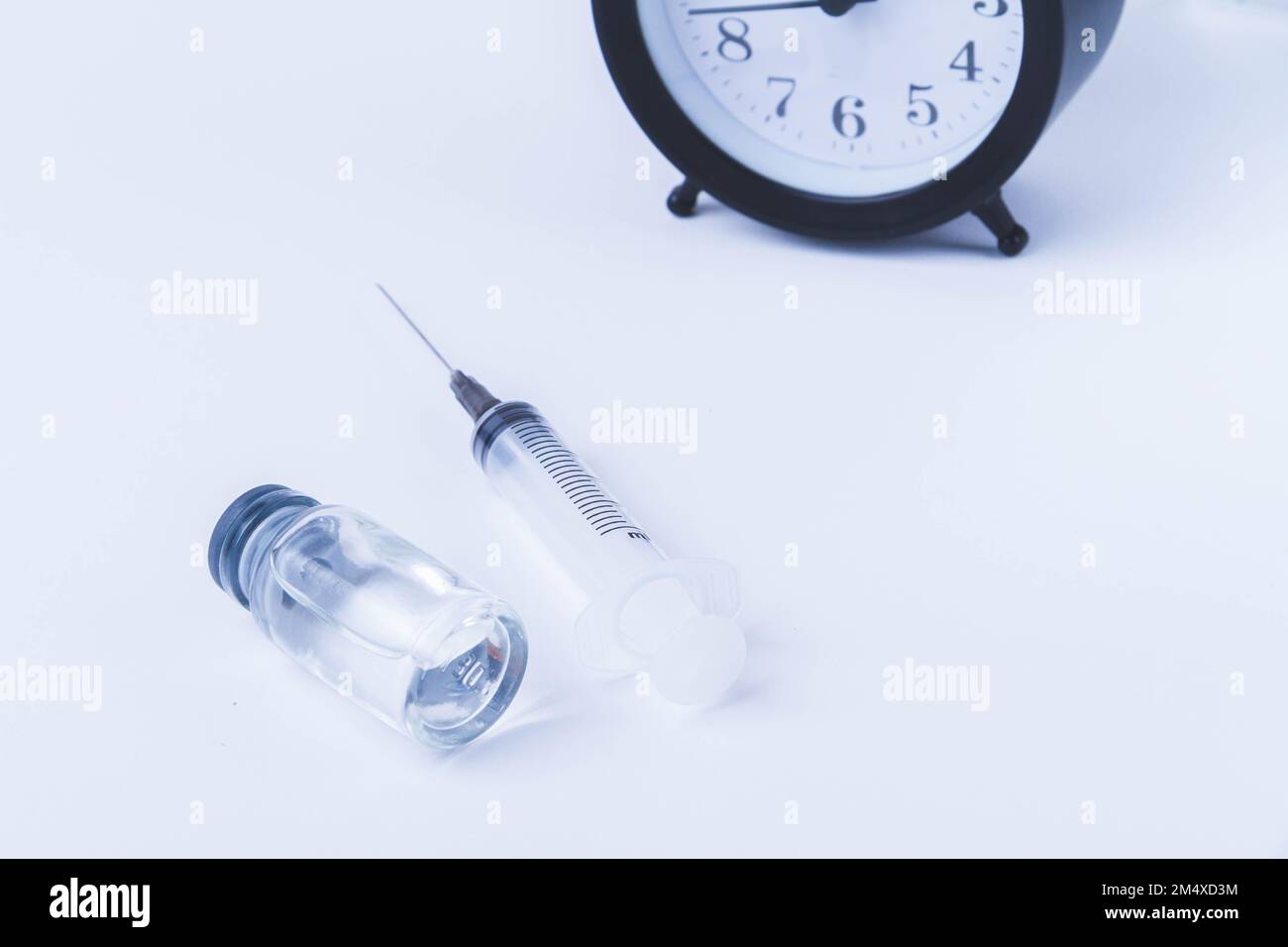 Time for vaccination. Watch and syringe with vaccine. Date and time of ...