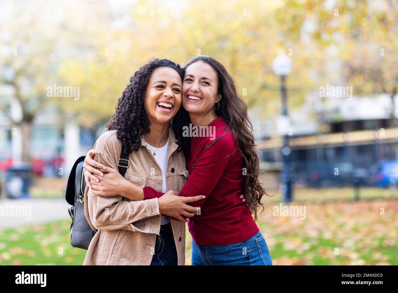 Happy women standing together in park Stock Photo - Alamy