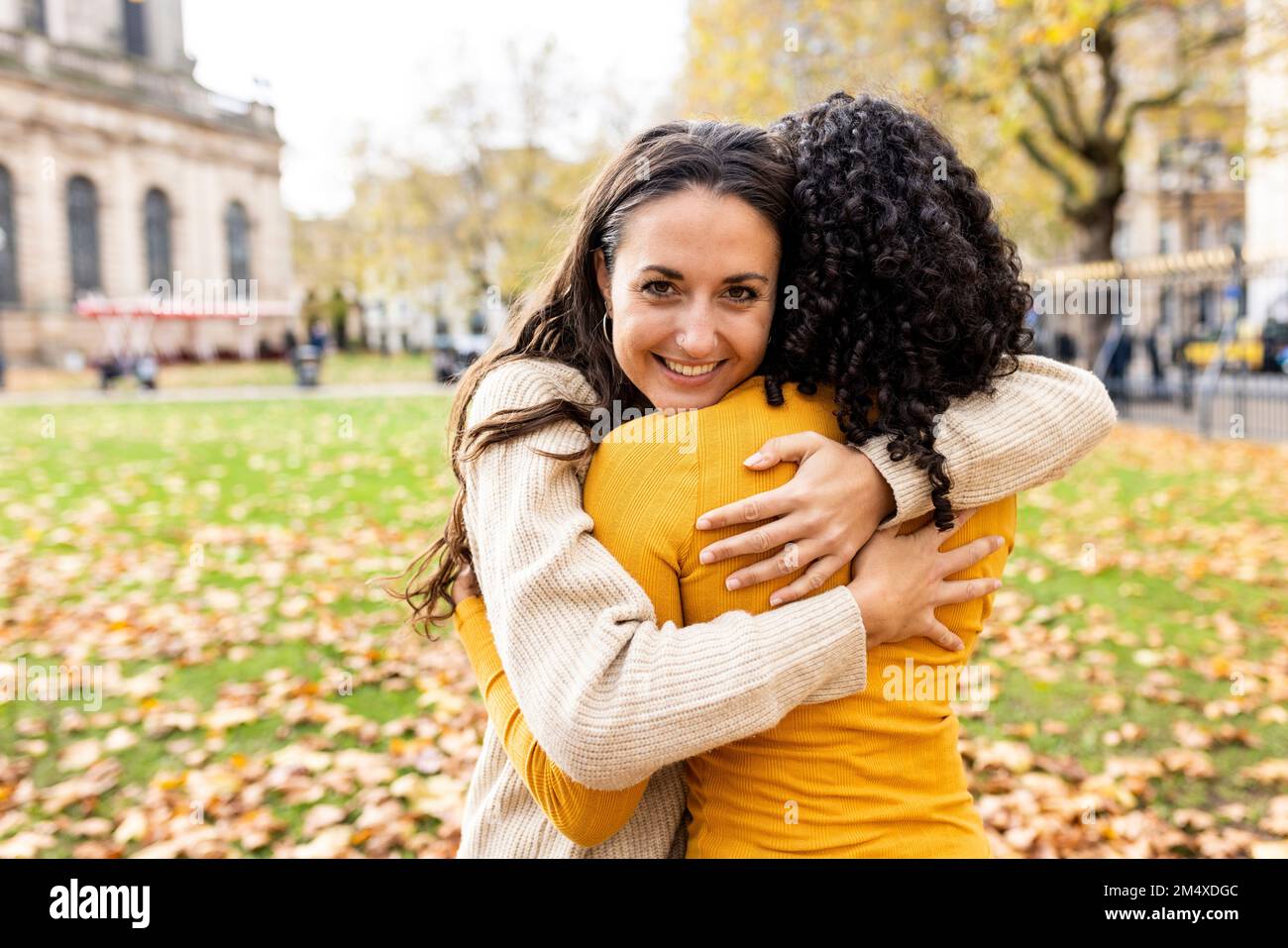Two female friends hugging rear view hi-res stock photography and ...