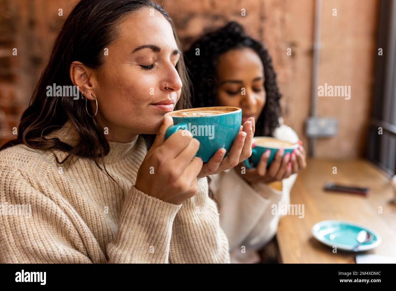 Women enjoying coffee at cafe Stock Photo - Alamy