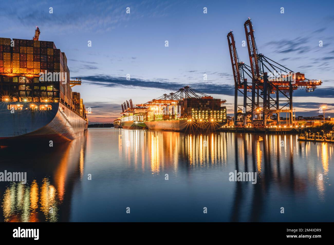 Germany, Hamburg, Container ships in Port of Hamburg at dusk Stock ...