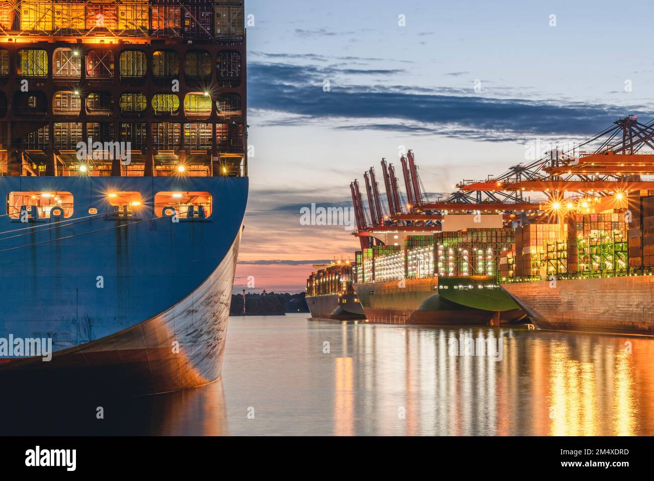 Germany, Hamburg, Container ships in Port of Hamburg at dusk Stock ...