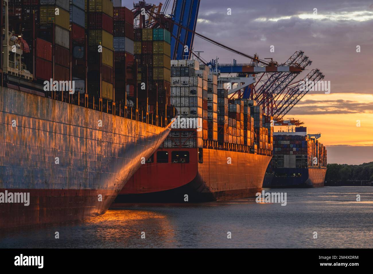 Germany, Hamburg, Container ships in Port of Hamburg at dusk Stock ...