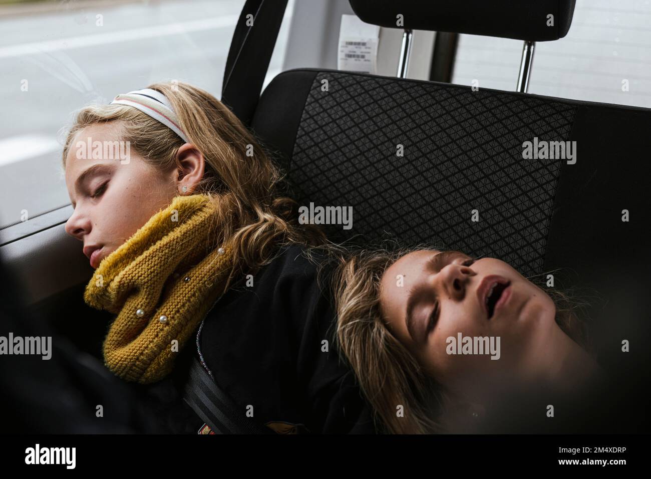 Girls sleeping together in car Stock Photo - Alamy