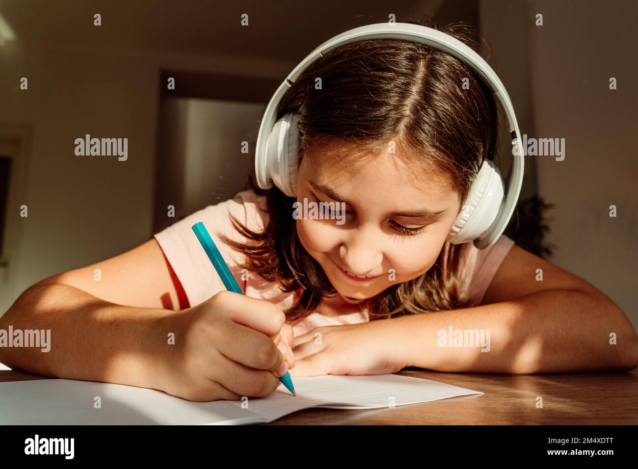 Schoolgirl in headphones homework hi-res stock photography and images ...