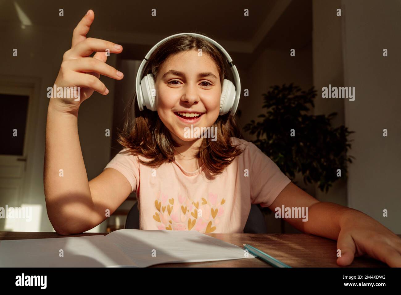 Happy girl wearing headphones sitting hi-res stock photography and ...