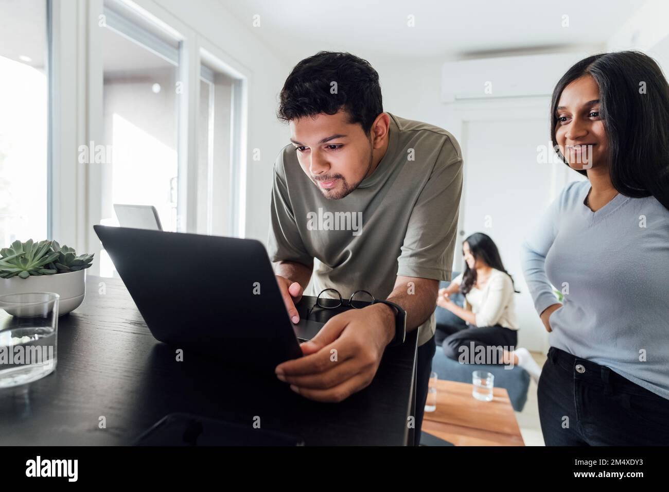 Young man bending over table hi-res stock photography and images - Alamy