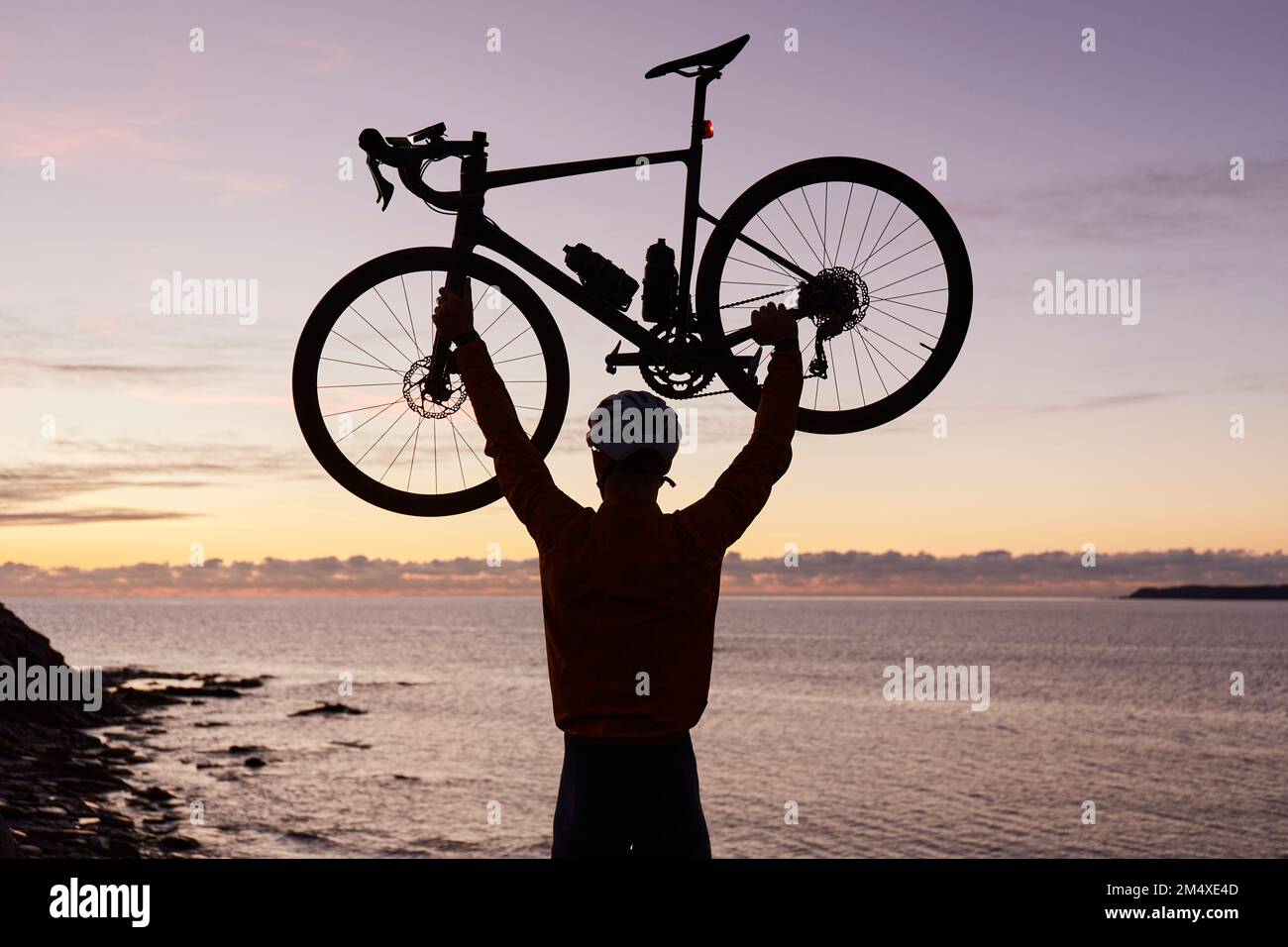 Man holding bike above head hi-res stock photography and images - Alamy