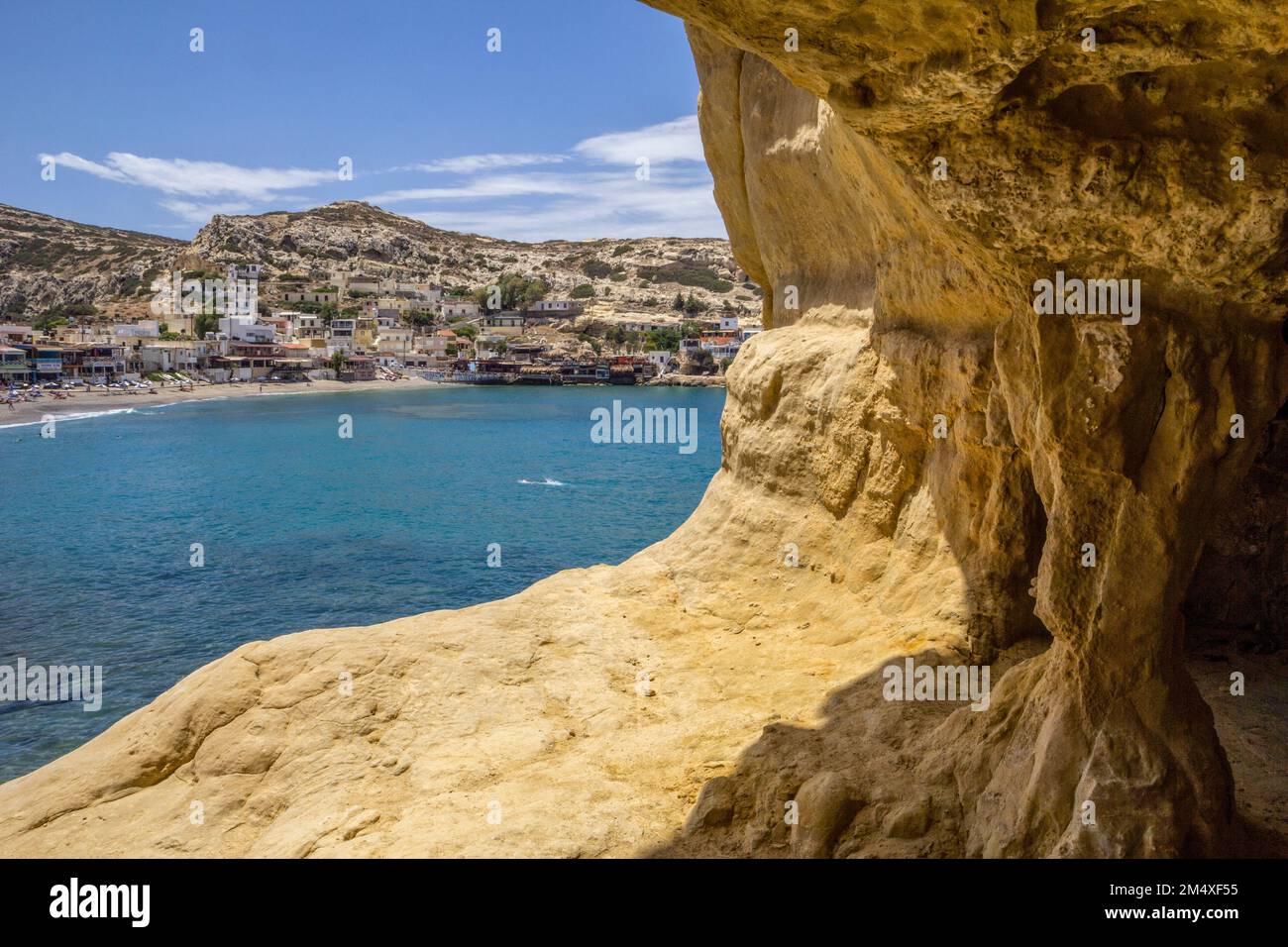 Greece, Crete, Matala, Coastal village seen from cliffside cave Stock ...