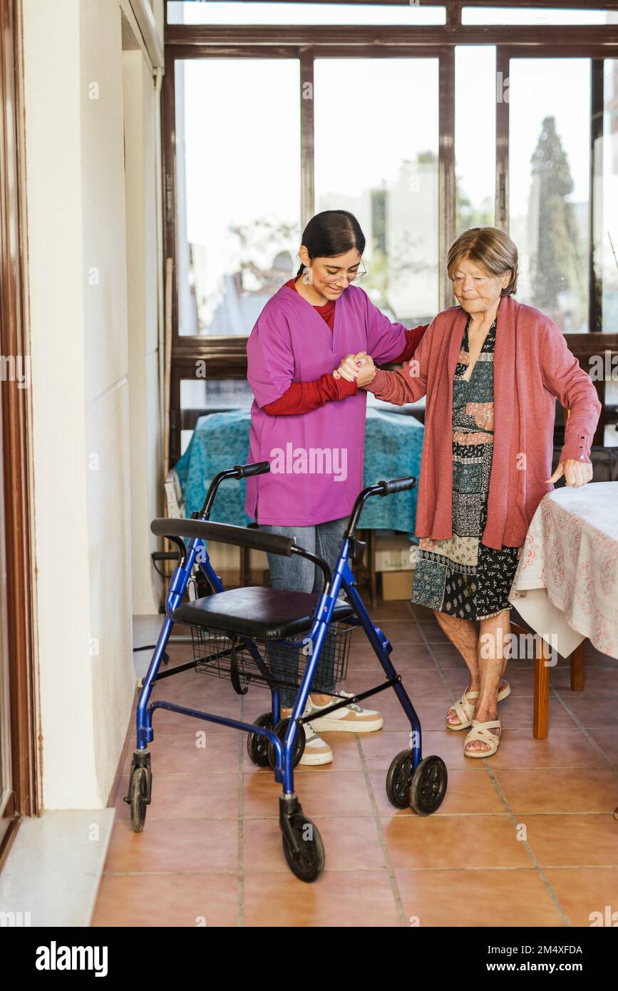 Young caregiver walking senior hi-res stock photography and images - Alamy
