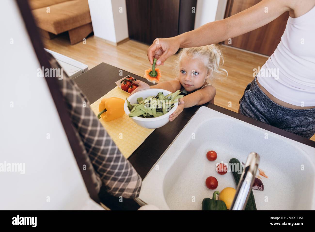 Collecting organic waste from vegetables in kitchen Stock Photo - Alamy