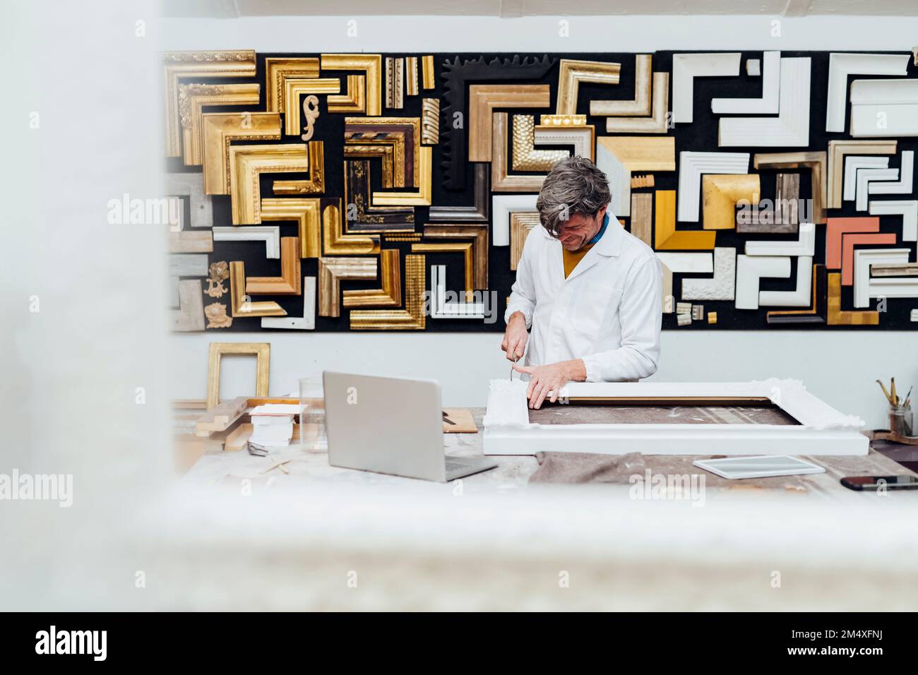 Craftsman making frame in workshop Stock Photo - Alamy