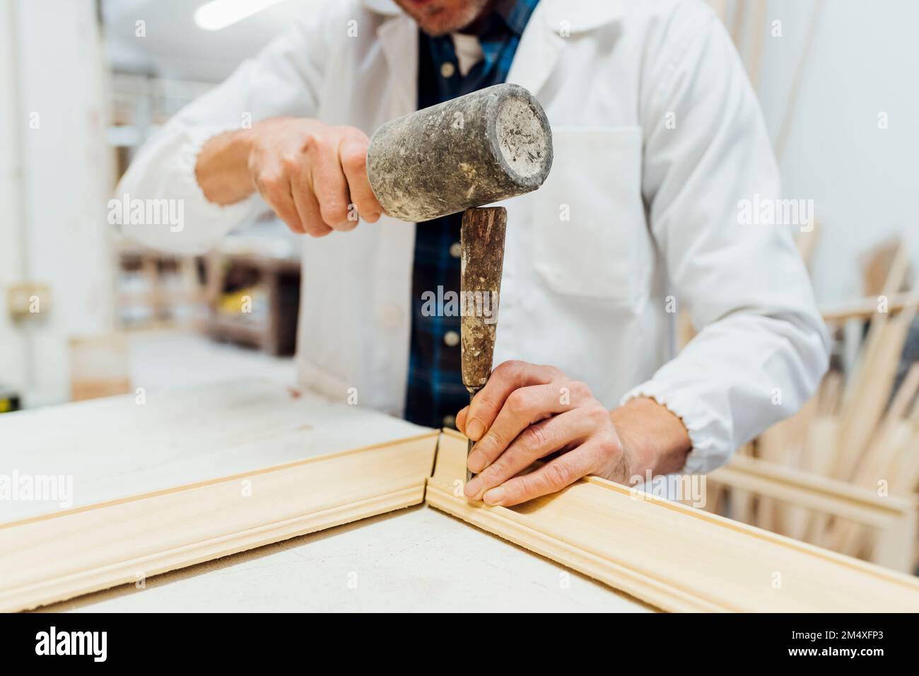 Hands of craftsman using work tool to make frame in workshop Stock ...