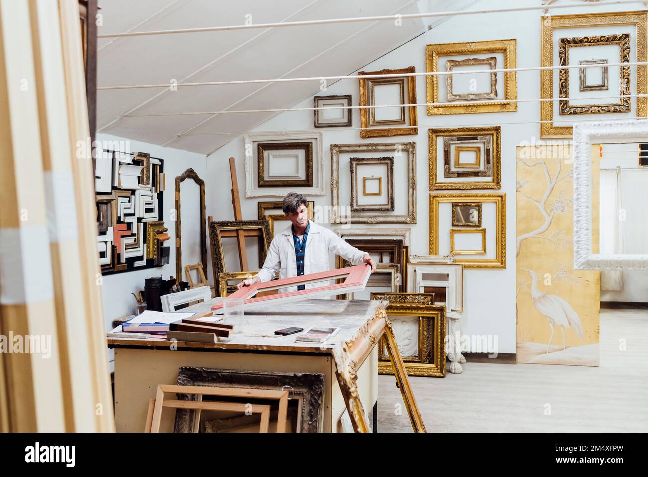 Carpenter making frames in workshop Stock Photo - Alamy