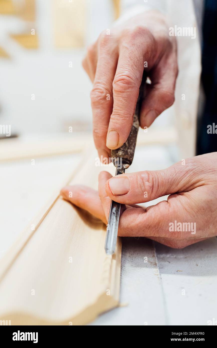 Craftsman carving wooden frame in workshop Stock Photo - Alamy